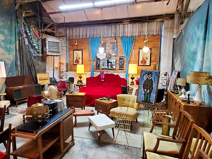 That crimson sofa commands attention like a movie star, surrounded by supporting cast members begging for their closeup.