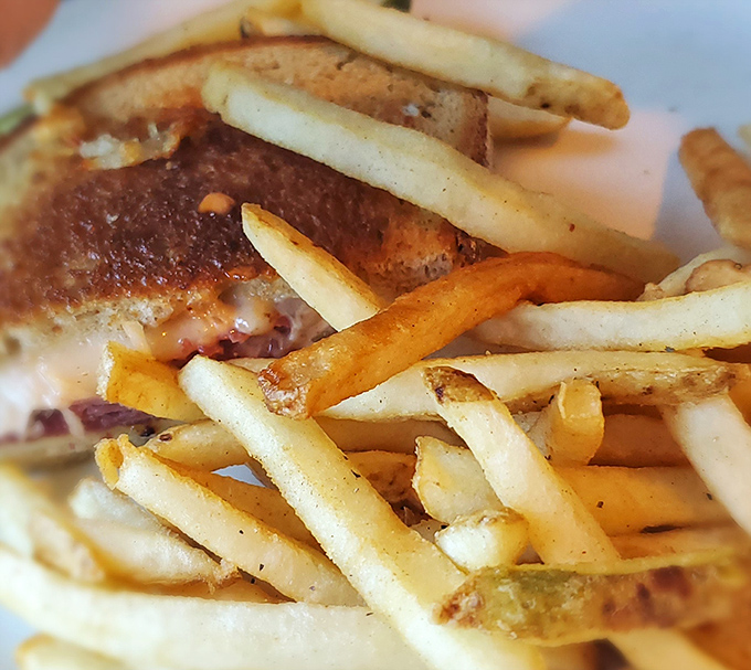 This isn't just a sandwich&mdash;it's architecture. Perfectly grilled rye, melty cheese, and that pile of fries that says "diet tomorrow, live today."