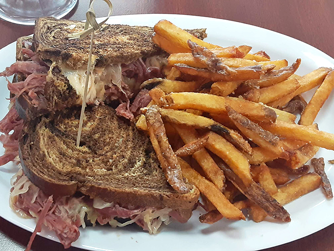 Behold the legendary Reuben&mdash;corned beef piled high on grilled rye with melted Swiss cascading into tangy sauerkraut. This isn't lunch, it's edible poetry.