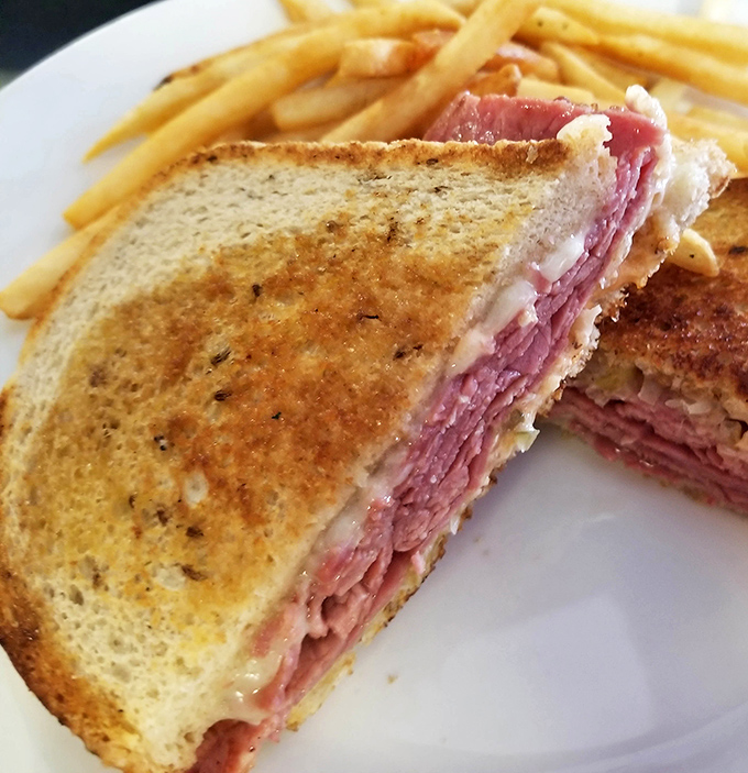 The legendary Reuben in all its glory—a skyscraper of corned beef and melted Swiss that makes Manhattan's delis nod in respectful approval.