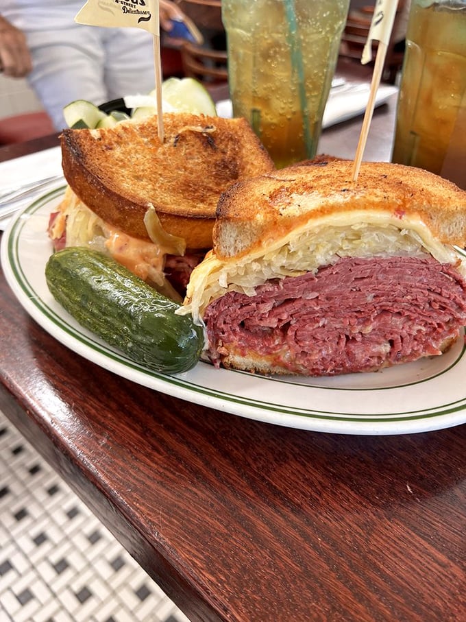 Behold the Reuben in all its glory &ndash; a skyscraper of corned beef, sauerkraut, and Swiss cheese that requires both hands, several napkins, and possibly a nap afterward.