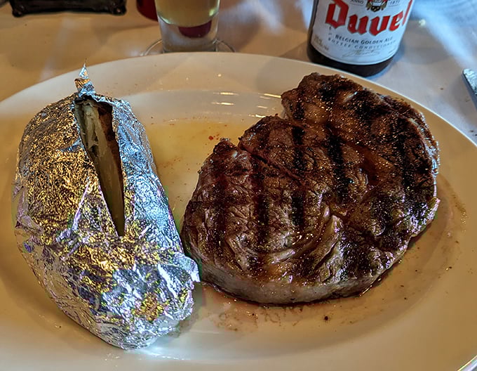 Behold the star of the show &ndash; a perfectly seared ribeye alongside a foil-wrapped potato that's practically begging to be unwrapped.