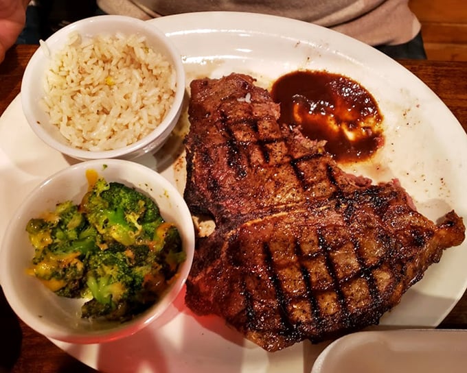 This ribeye arrives with perfect crosshatch grill marks, flanked by buttered rice and broccoli like loyal courtiers.