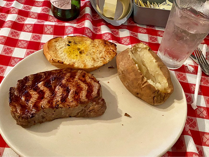 Grill marks that deserve their own hall of fame. This thick-cut beauty with a butter-laden potato is what carnivore dreams are made of.