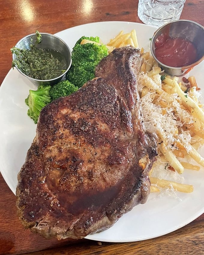 Behold the star of the show: a perfectly seared ribeye with a crust that crackles like autumn leaves, accompanied by sides that know their supporting role.