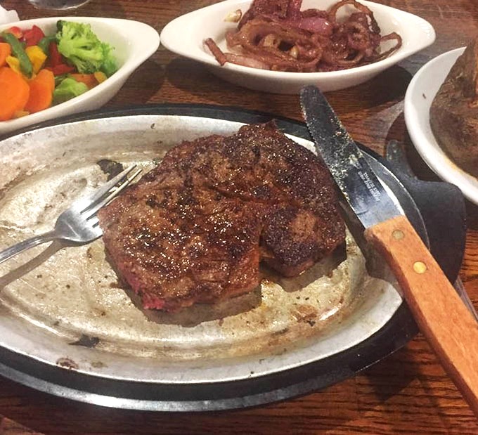 Behold the ribeye in its natural habitat—perfectly seared, gloriously marbled, and ready for its moment of carnivorous fame.