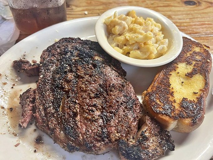 A perfectly mesquite-grilled ribeye that doesn't need a fancy plate to announce its greatness. That char speaks volumes.
