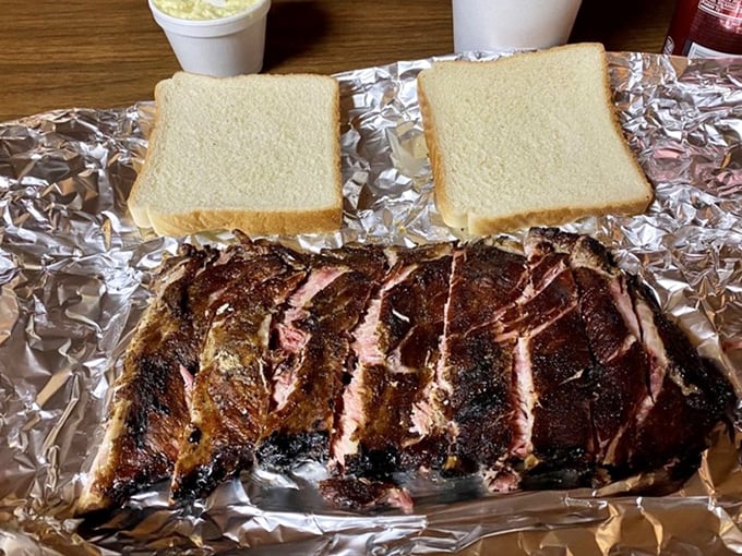 Behold the star of the show: ribs served with white bread on foil. No fancy plates needed when you're busy creating memories one smoky bite at a time.