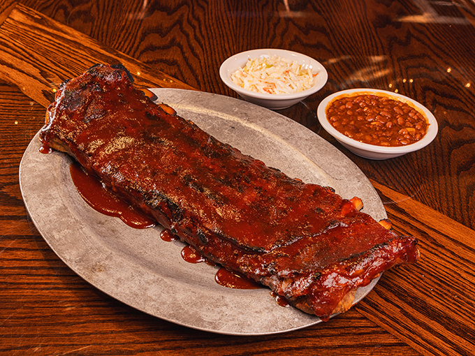 Behold the star attraction: Fall-apart tender ribs with that perfect pink smoke ring, glistening with sauce that should be bottled and sold as cologne.