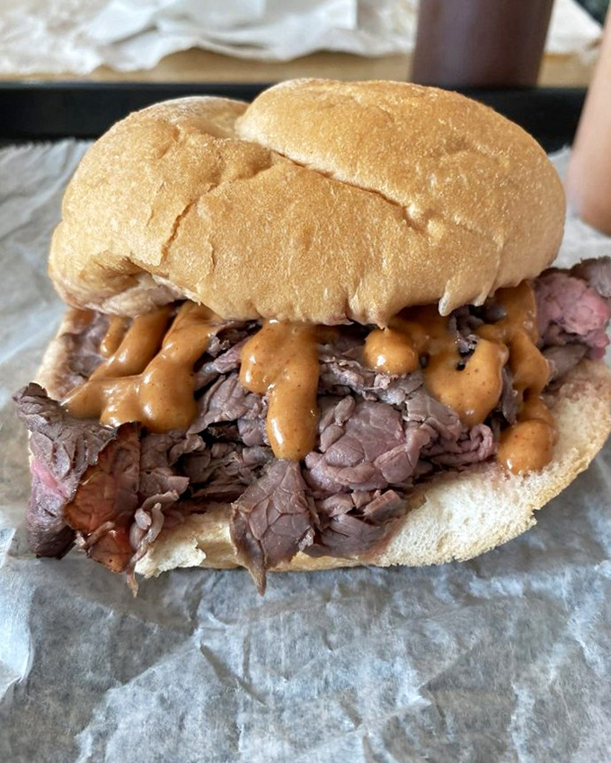 Behold the star of the show! Tender roast beef piled high on a steamed kaiser roll with tangy sauce. This isn't just lunch&mdash;it's a religious experience.