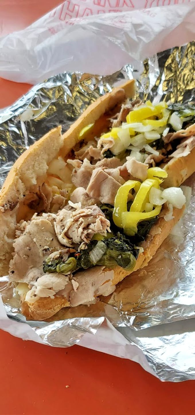 Behold the star attraction: tender roast pork, sharp provolone, and garlicky broccoli rabe creating a holy trinity of flavor in every bite.