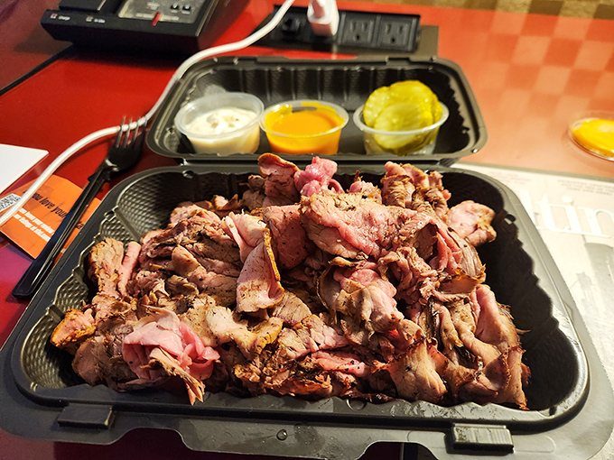 Behold the star of the show: paper-thin slices of smoky pit beef piled high, ready to make your cardiologist nervously update your chart.