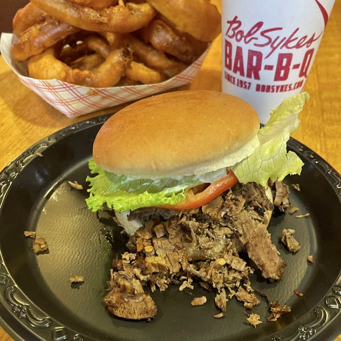 That's not just a sandwich; it's a structural engineering marvel where smoke-kissed beef plays hide-and-seek with fresh veggies on a perfectly pillowy bun.