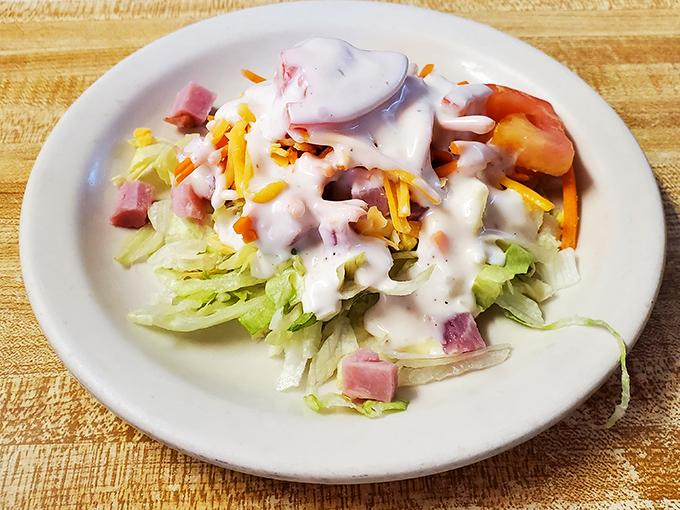 This isn't just any salad&mdash;it's the opening act that politely suggests saving room while knowing full well you'll be back for seconds of everything.