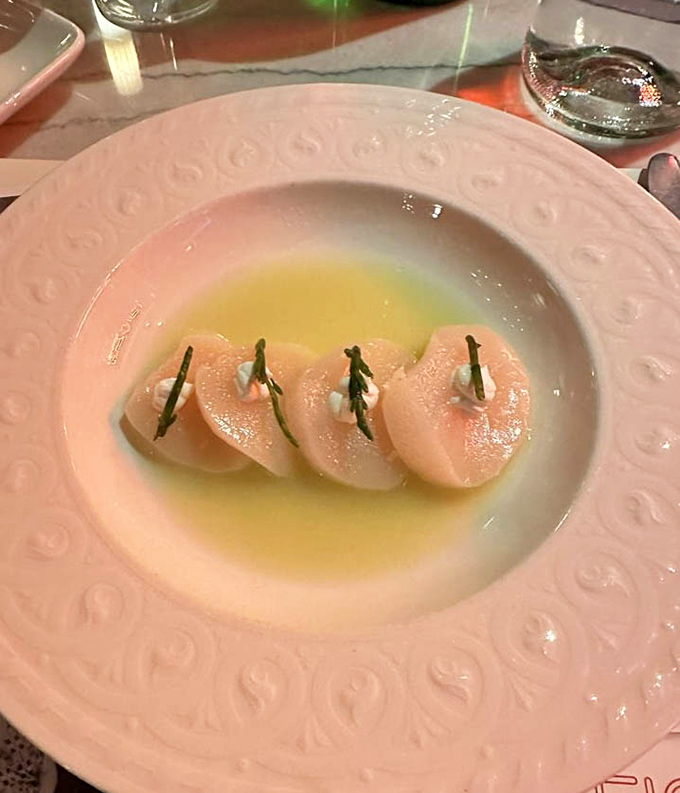 These scallops aren't just cooked&mdash;they're respected. Delicately arranged with fresh herbs in a buttery bath that would make Neptune himself weep with joy.