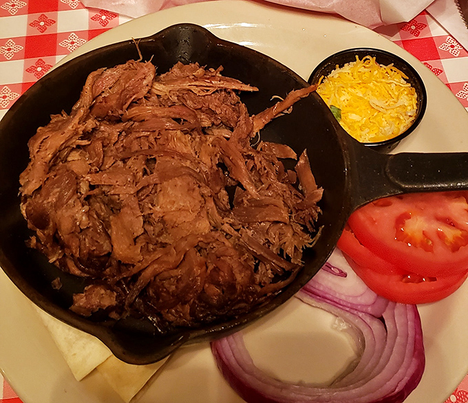 Behold the star of the show! This shredded pit beef doesn't just fall apart&mdash;it surrenders completely, accompanied by melted cheese and fresh veggies.
