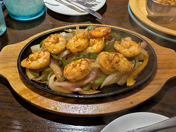 Sizzling shrimp fajitas that announce their arrival before you see them. That cast iron skillet keeps the conversation going long after the first bite.
