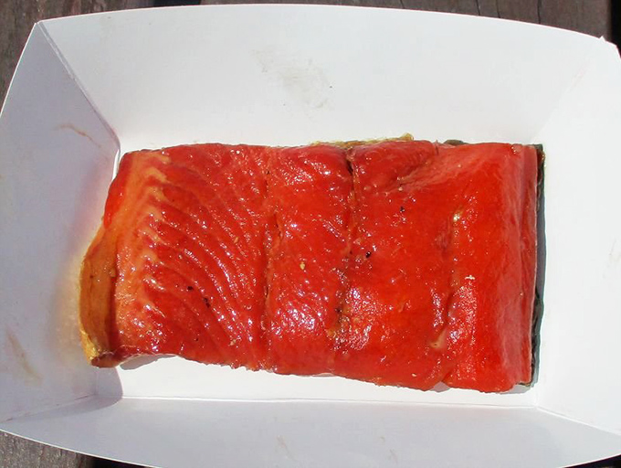 Behold the star attraction: smoked salmon so vibrantly red it looks like nature's candy, glistening with promises of smoky perfection. 