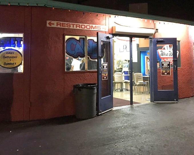 The neon-lit entrance to cinematic paradise. Walking through these doors is like stepping into a time machine where popcorn still reigns supreme.
