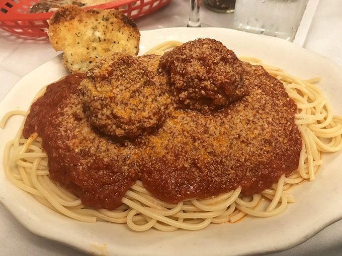 Spaghetti and meatballs that would make your Italian grandmother weep with joy—perfectly twirled pasta swimming in rich, ruby-red sauce.