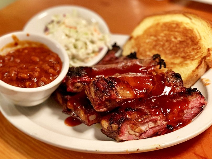 These St. Louis ribs aren't just cooked &ndash; they're coaxed into tenderness through hours of patient smoking, resulting in that perfect pink smoke ring that makes barbecue lovers weak in the knees.