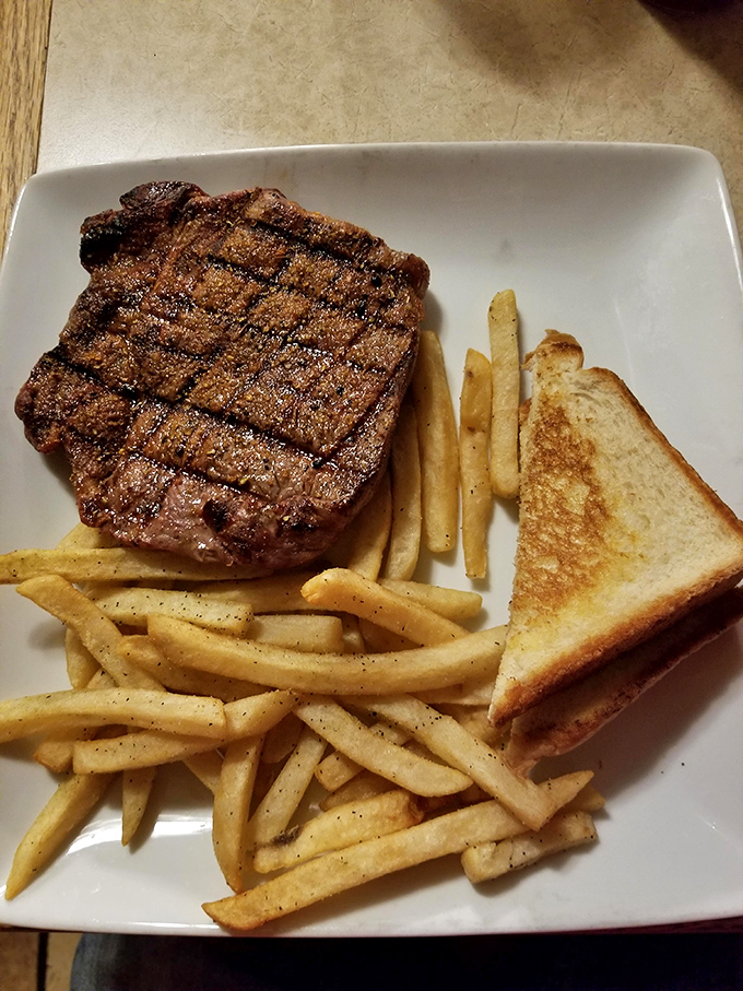 This isn't just a steak&mdash;it's a declaration of independence from mediocre meals. Perfect grill marks, golden fries, and Texas toast complete the all-American trifecta.