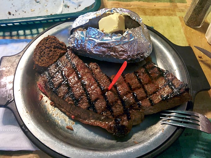 This isn't just a steak; it's a masterpiece of simplicity&mdash;perfectly grilled, gloriously juicy, and paired with a foil-wrapped potato that's practically begging to meet its butter destiny.