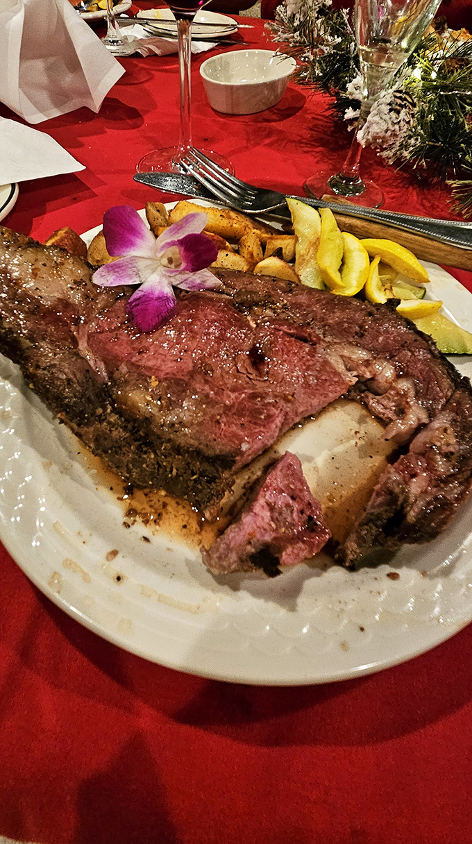 A perfectly cooked steak garnished with an orchid&mdash;because when your beef is this good, it deserves its own formal wear.