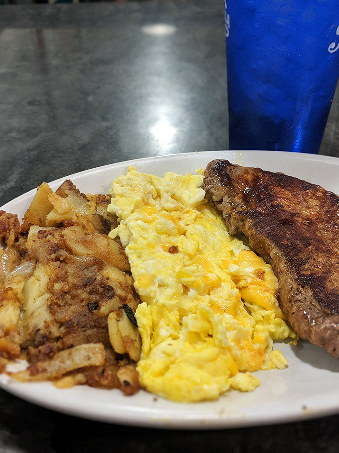 The breakfast trinity: crispy home fries, fluffy scrambled eggs, and a perfectly seared steak. This plate doesn't just feed you&mdash;it restores your faith in mornings.