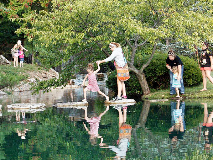 Families discover the joy of stone-hopping across still waters. These stepping stones invite both playful adventure and mindful focus&mdash;choose your own path.