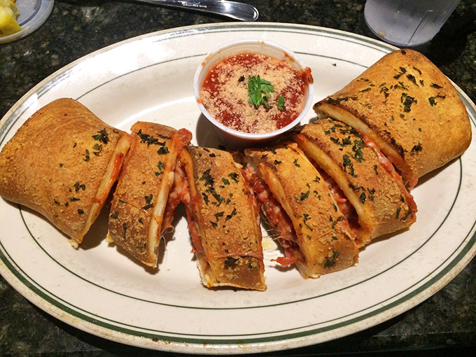 The star attraction: golden-brown stromboli sliced to reveal its treasure of meats and cheese, served with marinara that demands to be dunked.