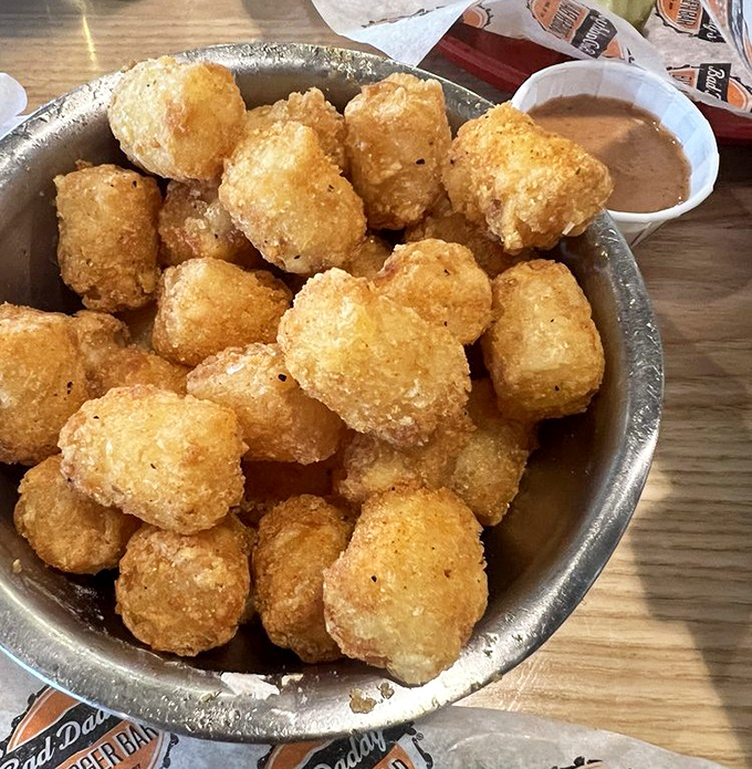 Golden orbs of potato perfection await the hungry traveler. These aren't your cafeteria's forgotten tots&mdash;they're crispy little time machines to childhood bliss.