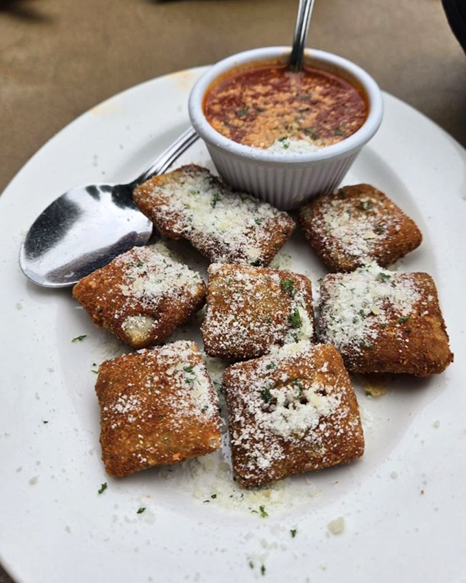 Golden-brown pillows of joy dusted with Parmesan snow. The toasted ravioli here isn't just food&mdash;it's edible art with a side of nostalgia.
