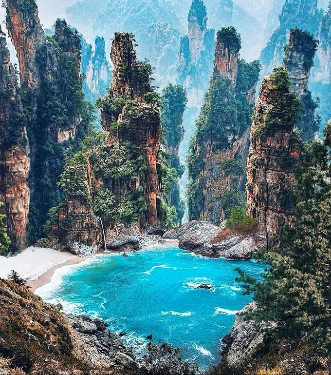 Mother Nature showing off again. These majestic stone pillars rising from turquoise waters look like Earth's version of winning the lottery.
