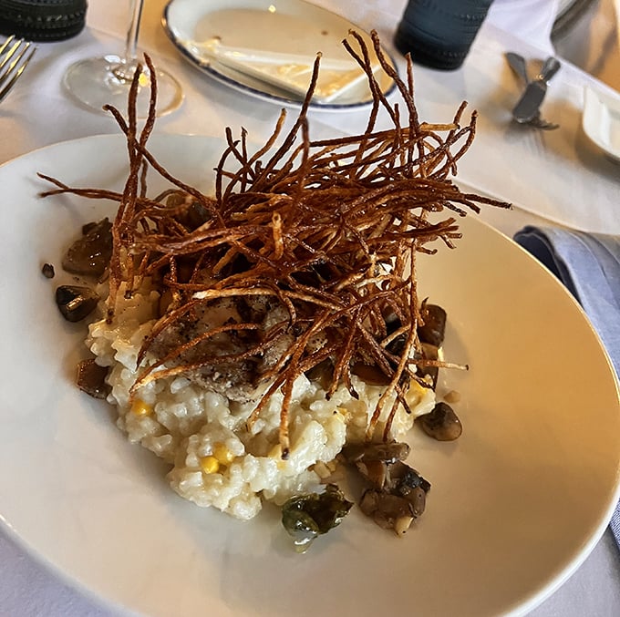 Truffle corn risotto crowned with crispy potato straws&mdash;proof that sometimes the most memorable relationships are between carbs and fungi.