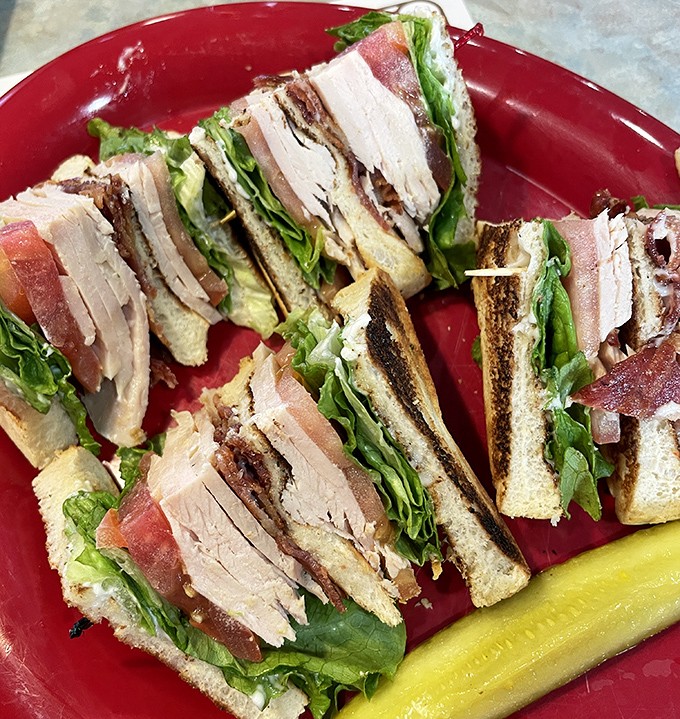 Behold the architectural marvel that is the turkey club &ndash; layers of real roasted turkey, crisp bacon, and fresh veggies creating the sandwich equivalent of the Taj Mahal.