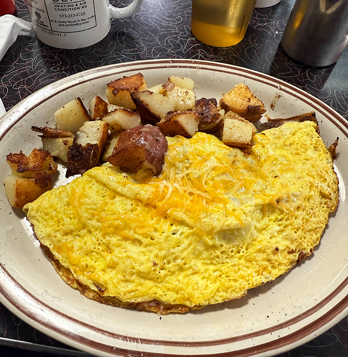 That golden omelet folded over perfectly with crispy potatoes is calling your name louder than your alarm clock.