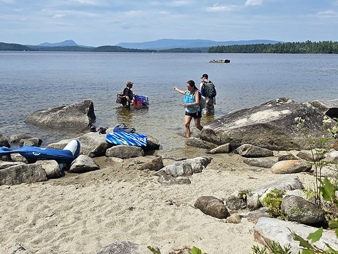 Beach explorers wade into Frenchman Bay's crystal waters. The mountains of Acadia create a backdrop worthy of a Maine tourism commercial.