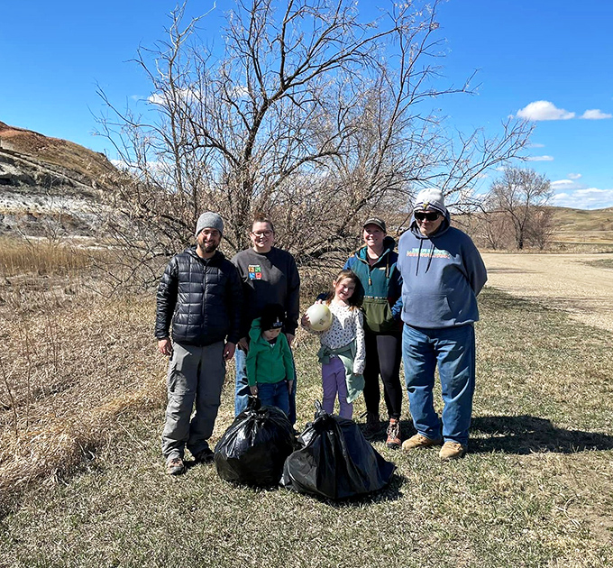 Conservation in action as visitors gather to help preserve this natural treasure. Nothing bonds a family like trash bags and a shared mission.