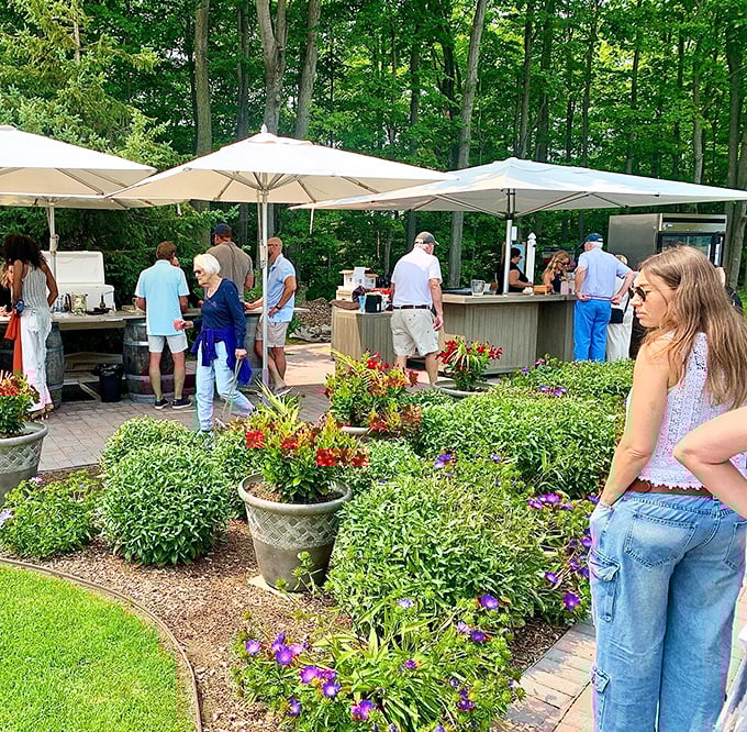 The outdoor tasting area buzzes with happy visitors sampling Michigan's finest under cheerful market umbrellas.