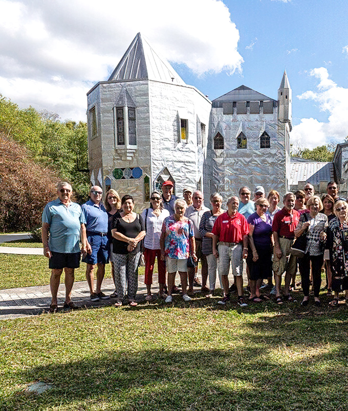 Happy explorers gather to document their castle adventure. In Florida's backroads, these folks found Camelot with a sunshine twist.