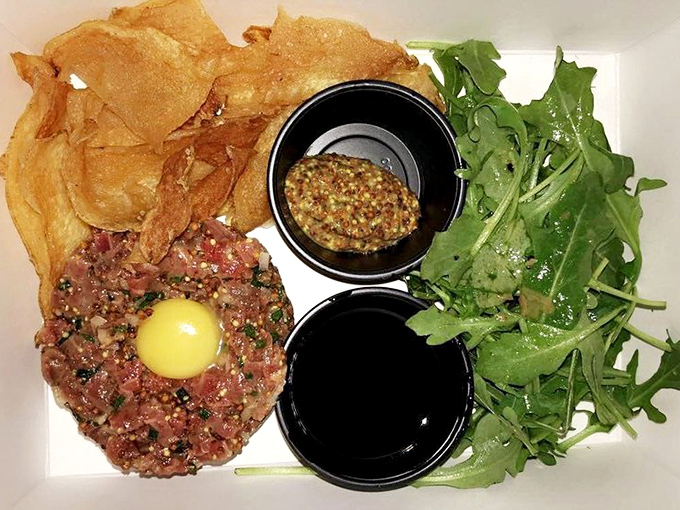 The legendary Wagyu beef tartare arrives like edible artwork&mdash;that vibrant egg yolk center practically winks at you with delicious intent.