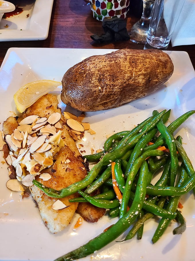 The star of the show: perfectly golden walleye served with vibrant green beans and a baked potato that's practically begging for a butter bath.