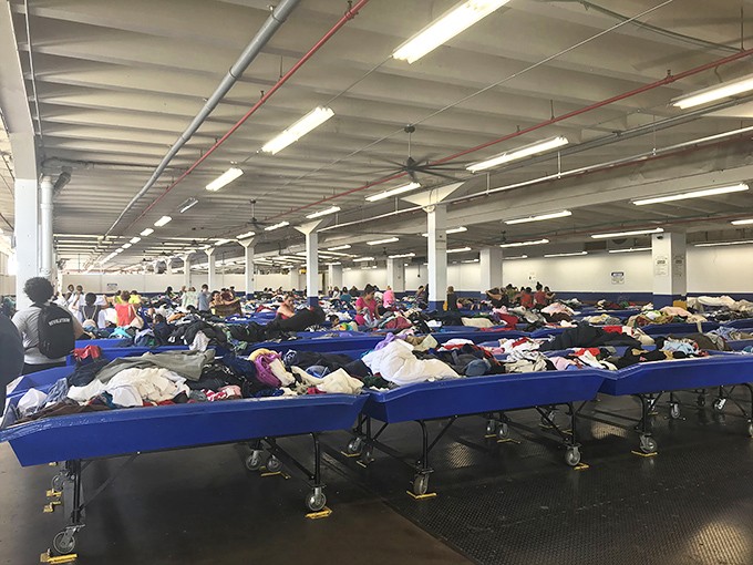Welcome to the thrifting Olympics! Shoppers strategically position themselves around bins, ready for the next great find.
