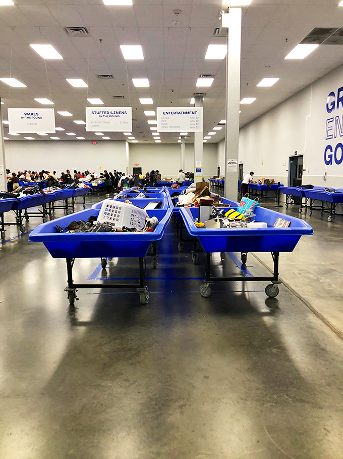 The warehouse view reveals the true scale of this operation&mdash;section signs hanging from the ceiling guide you through this labyrinth of potential finds.