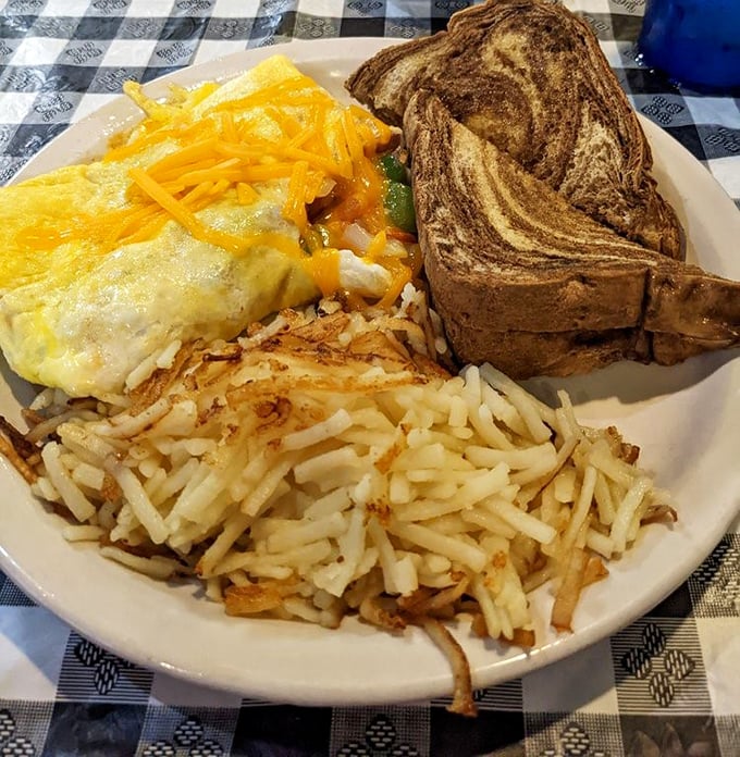Behold the star of the show: a Western omelette that achieves that perfect balance of fluffy eggs, savory ham, and vegetables with just enough cheese to make you smile.
