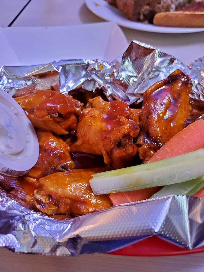 These wings aren't just sauced, they're transformed – glistening with tangy-sweet glory and accompanied by the obligatory celery sticks nobody actually eats.
