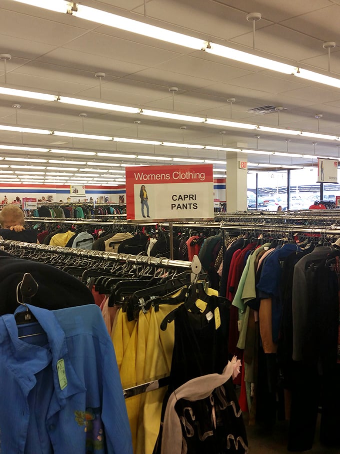 Rows upon rows of women's clothing await new homes. The thrill of the hunt is real&mdash;somewhere in there is the perfect capri pants.