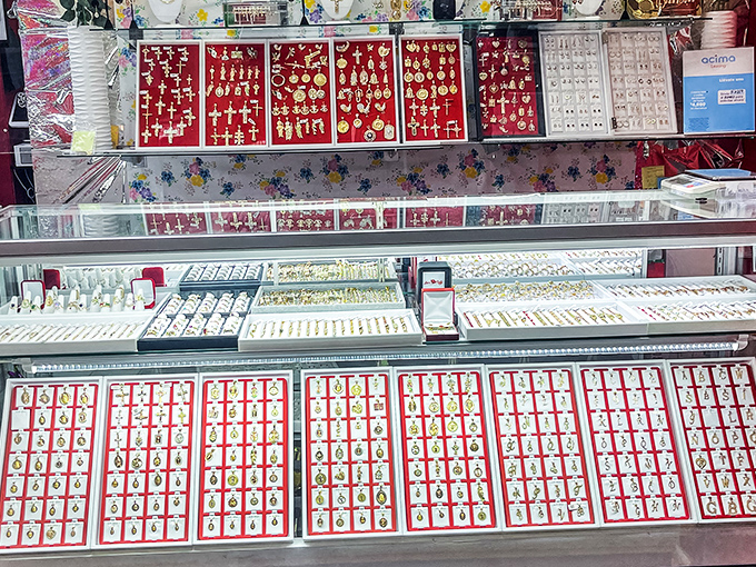 Gold gleams from display cases like pirate treasure, with religious medallions and crosses that transform jewelry shopping into a cultural experience.