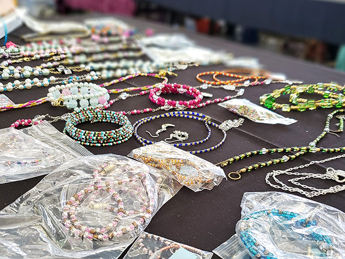 Colorful beaded jewelry sprawls across dark fabric like a constellation of wearable art. Each piece whispers, "Take me home, I'll make that outfit pop!"